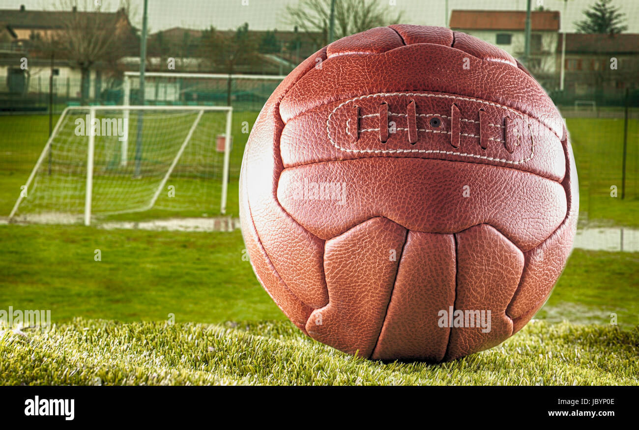 Old vintage football over a small football field Stock Photo - Alamy