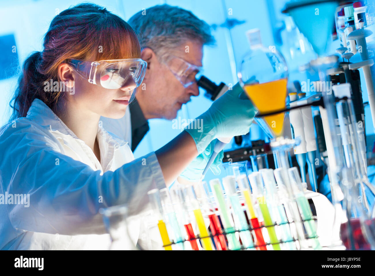 Attractive young female scientist and her senior male supervisor ...