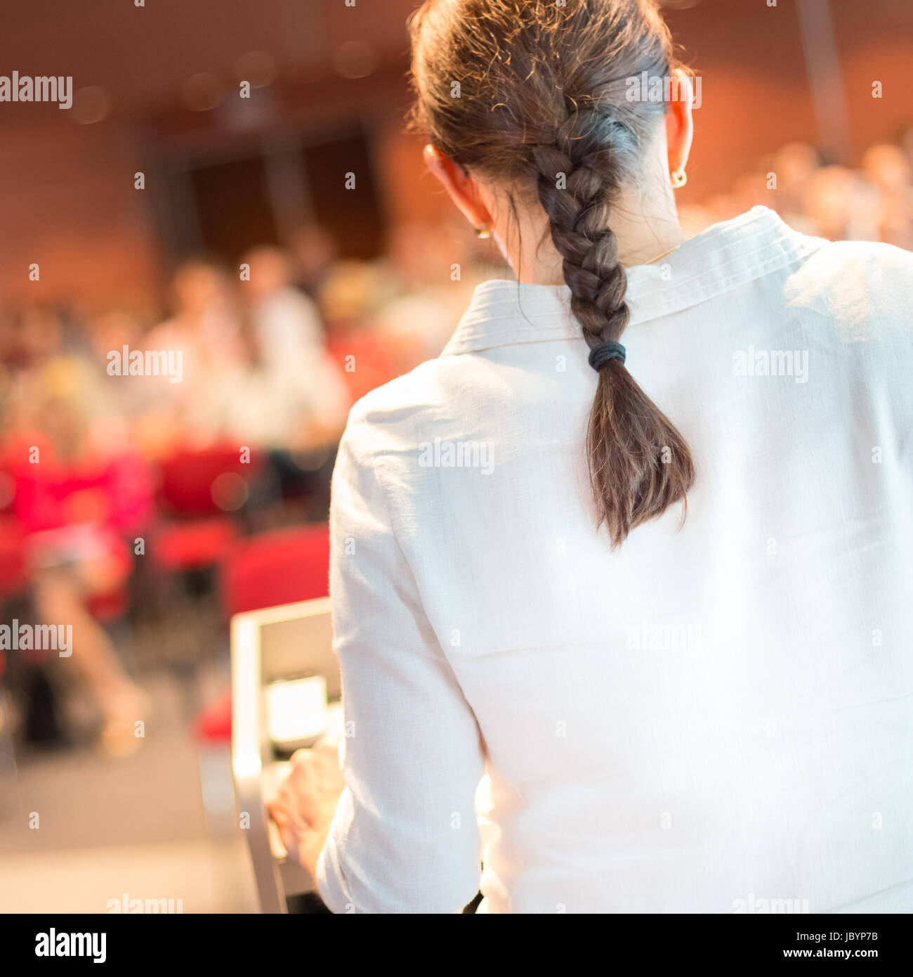 Female academic professor lecturing at Conference. Audience at the ...
