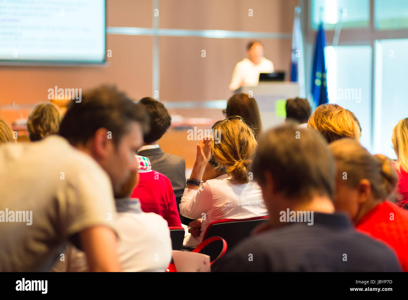 Female academic professor lecturing at faculty. Students at the lecture ...
