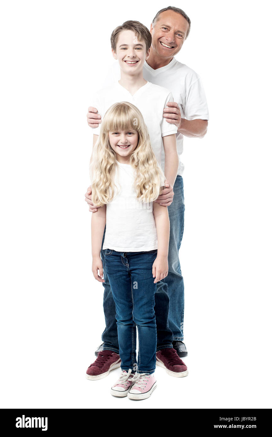 Happy father with children standing one behind another Stock Photo - Alamy