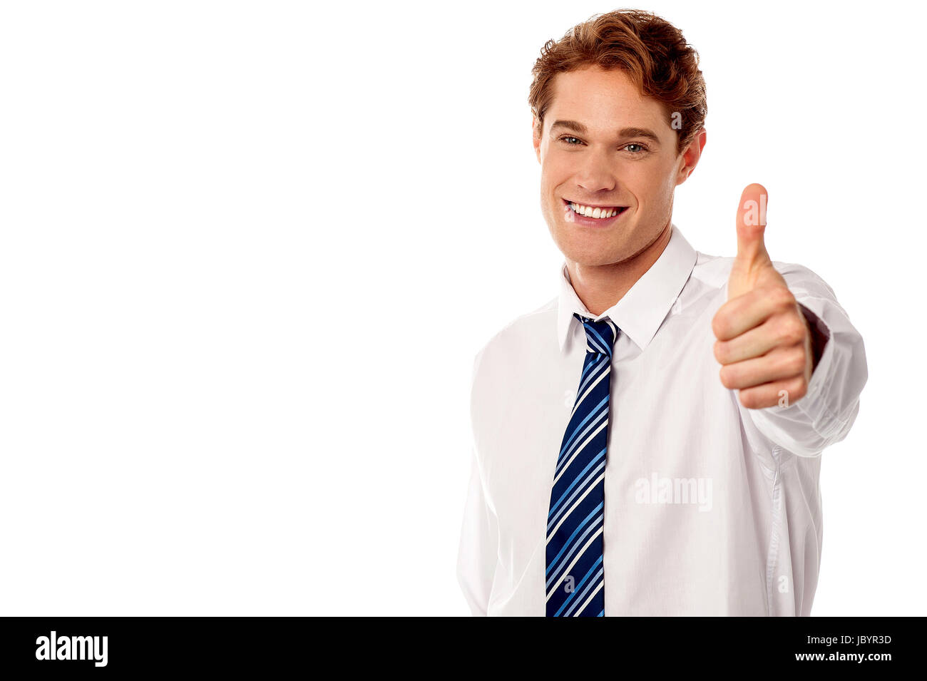Smiling young business manager showing thumbs up Stock Photo - Alamy