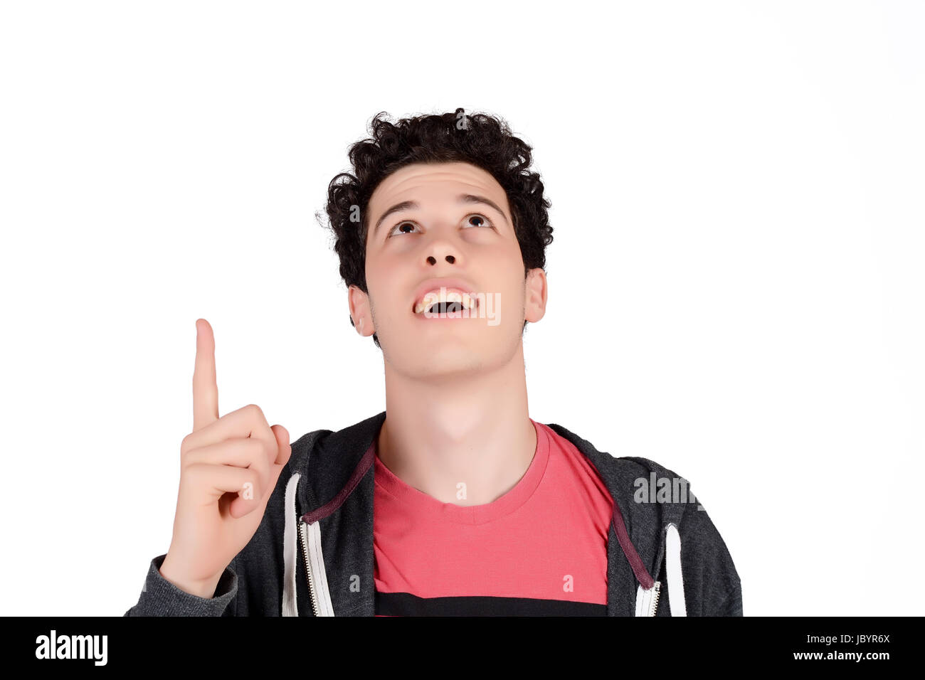 Portrait of attractive young man pointing up. Isolated white background ...