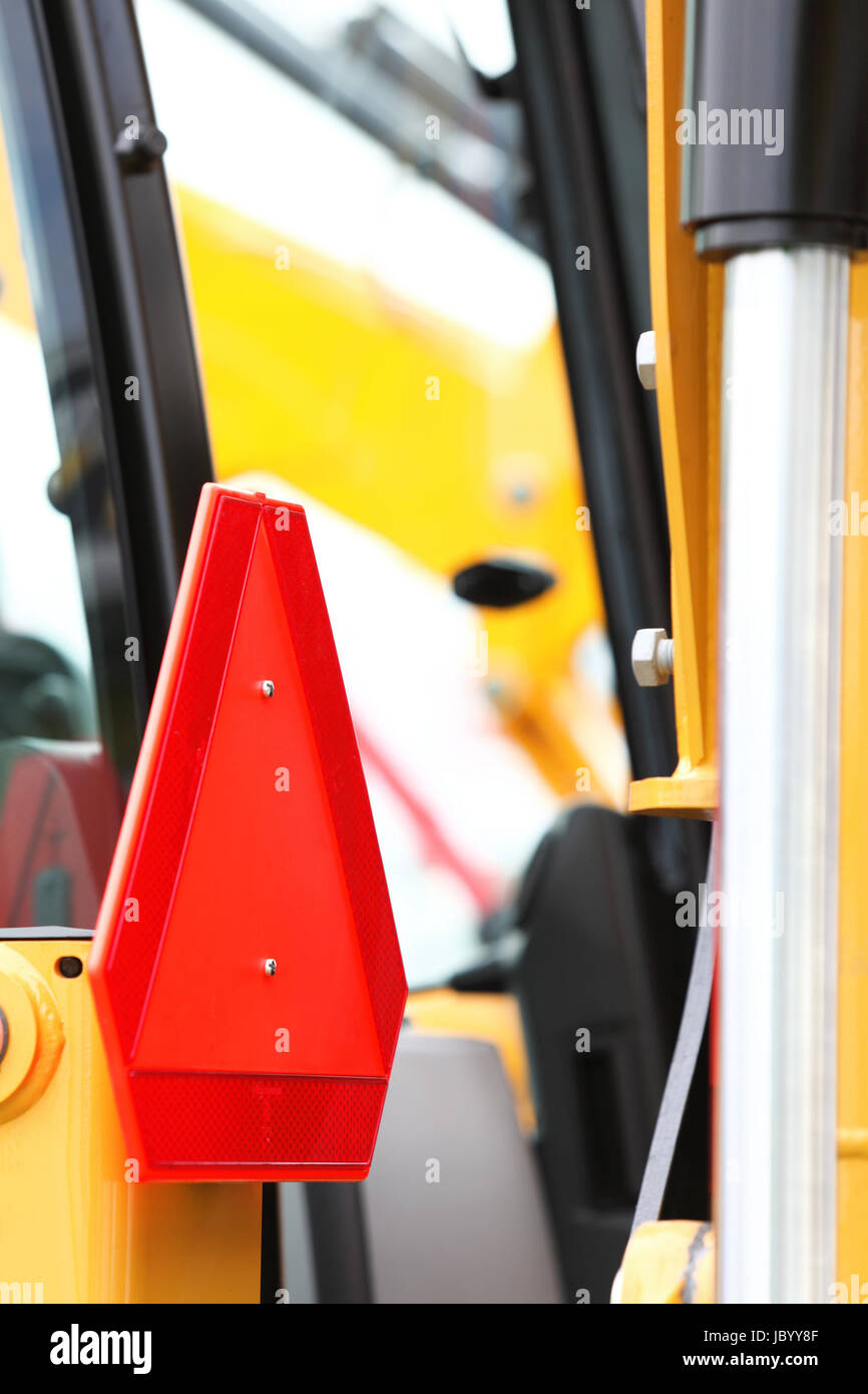 Detail industry machine with reflective slow moving vehicle warning ...