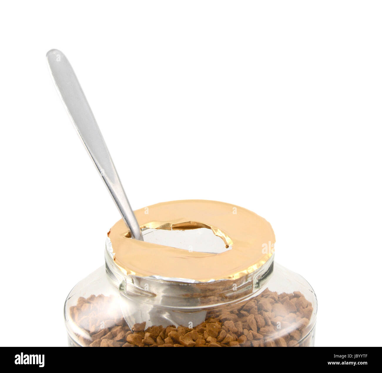 Metal teaspoon rests in a freshly opened jar of aromatic instant coffee ...