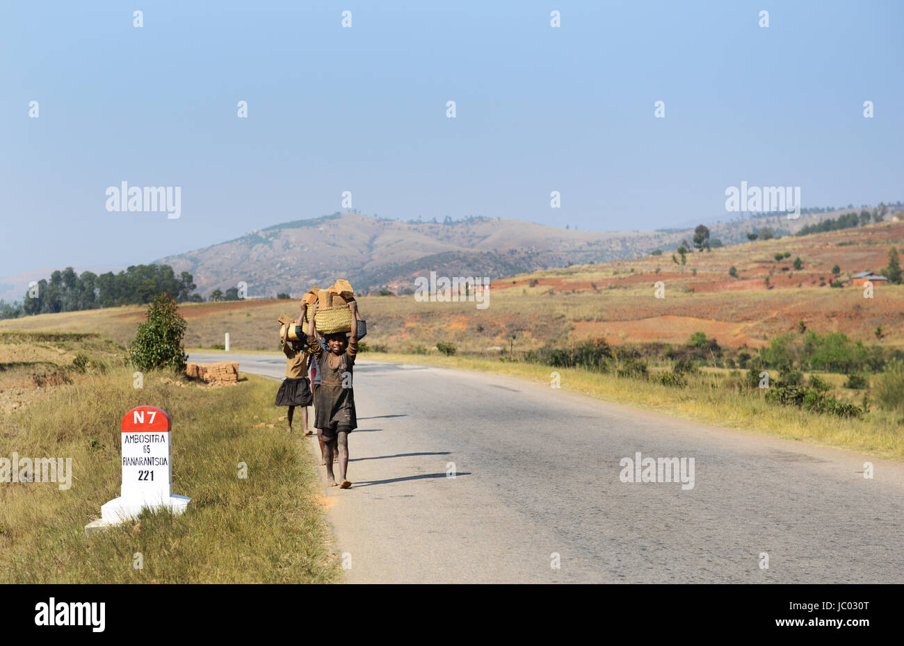 Children carrying heavy bricks in rural Madagascar Stock Photo - Alamy