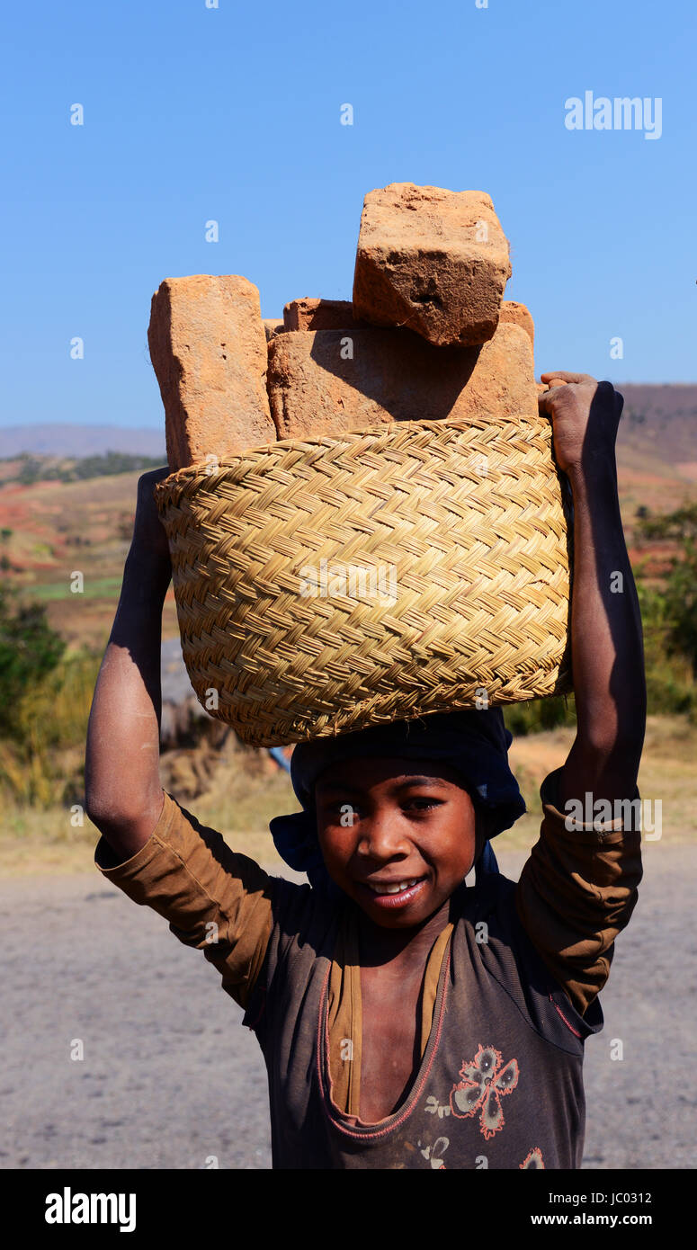 Children carrying heavy bricks in rural Madagascar Stock Photo - Alamy