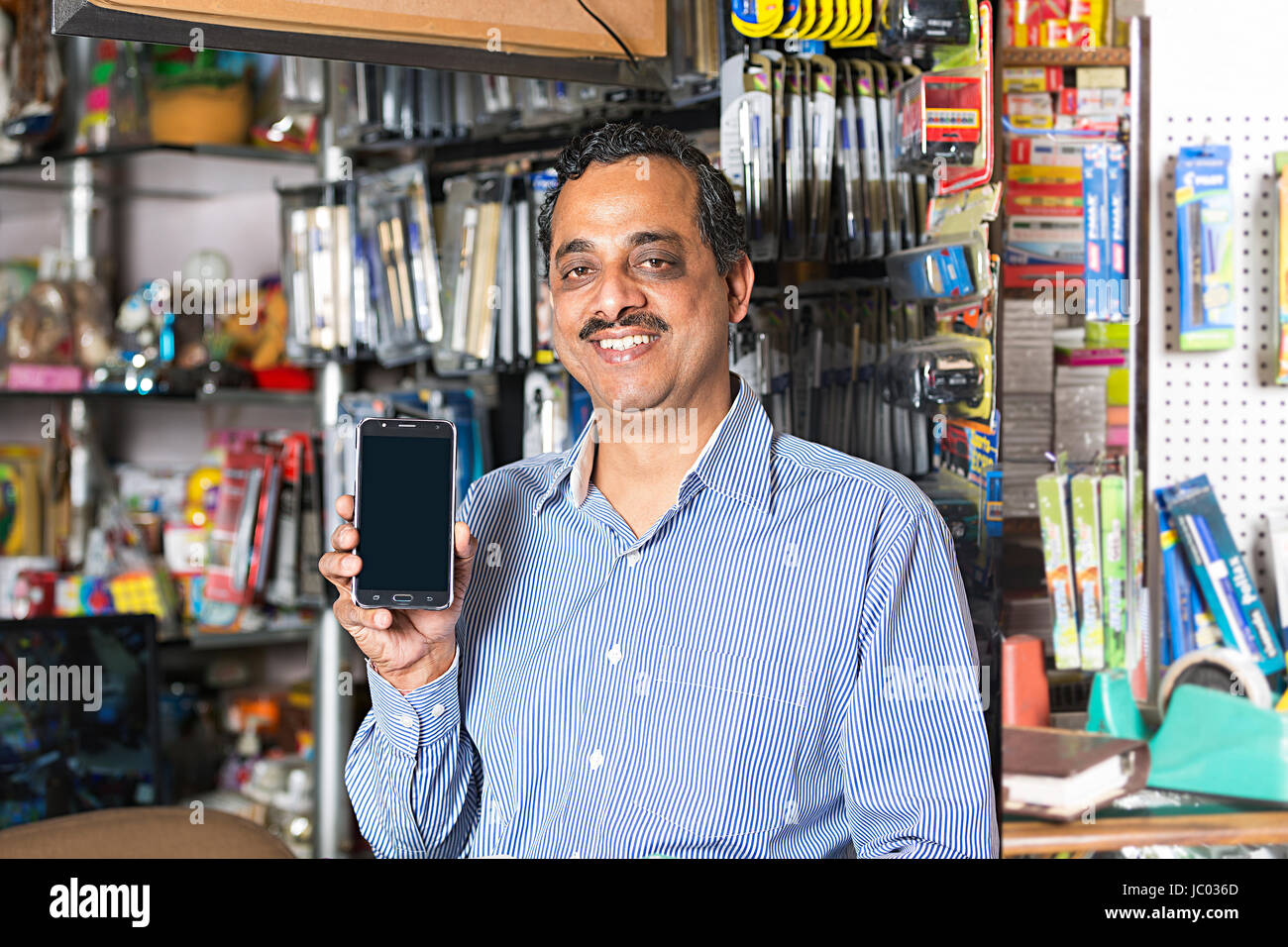 Male shopkeeper in phone hi-res stock photography and images - Alamy