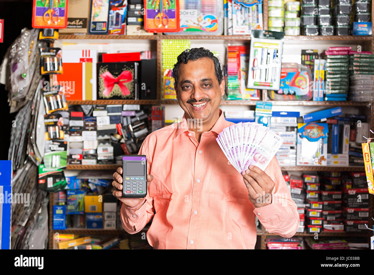 1 Indian Shop Keeper Man Showing Money Cash With Credit Card Reader In ...
