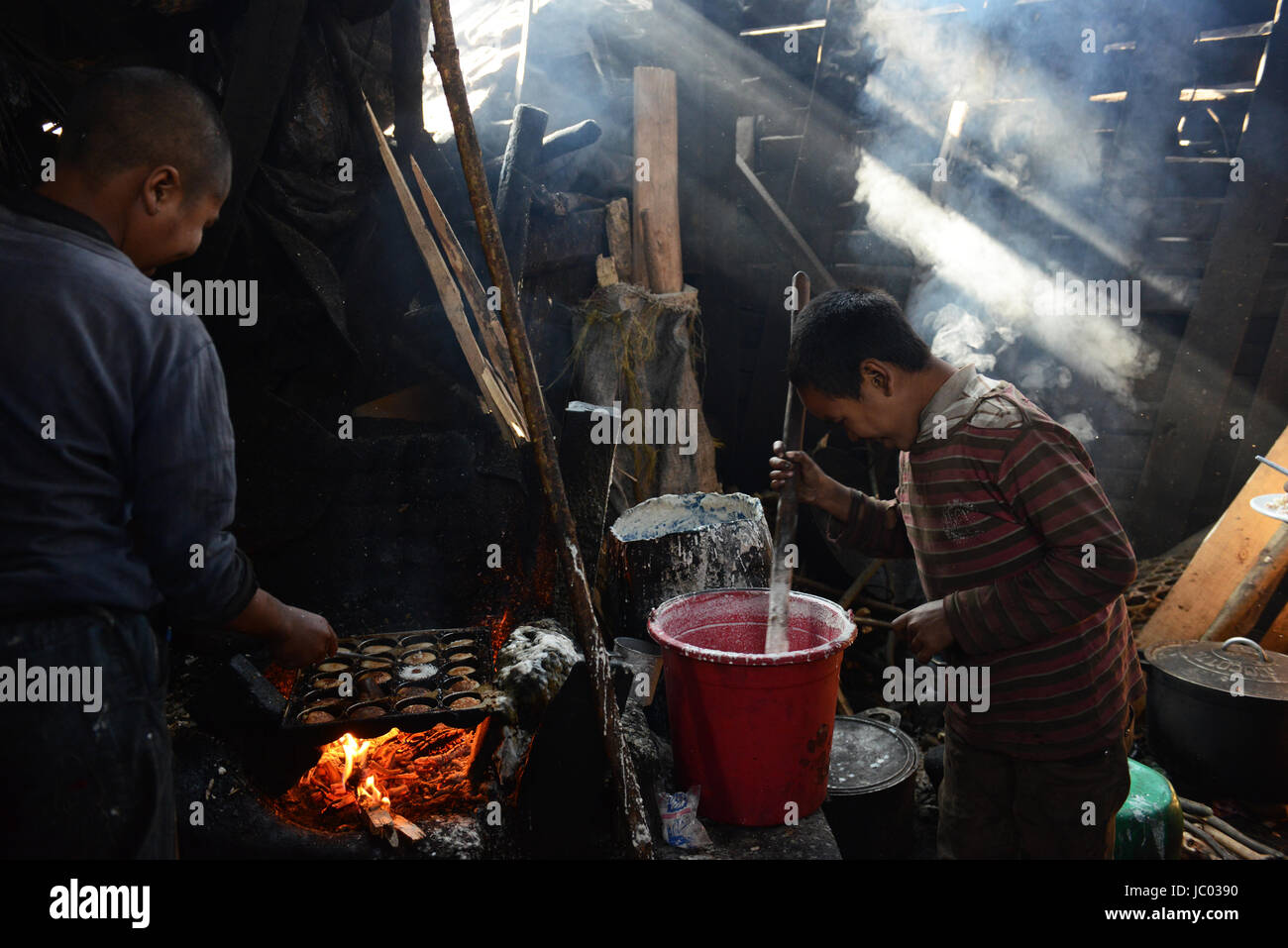 Cooking Mofo Gasy- Traditional Malagasy rice cakes in a small roadside ...