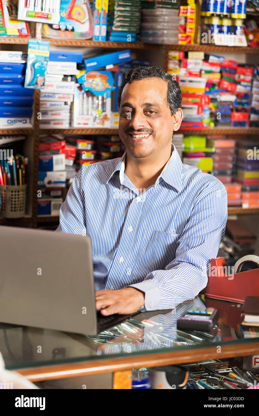 Indian shop keeper using technology hi-res stock photography and images ...
