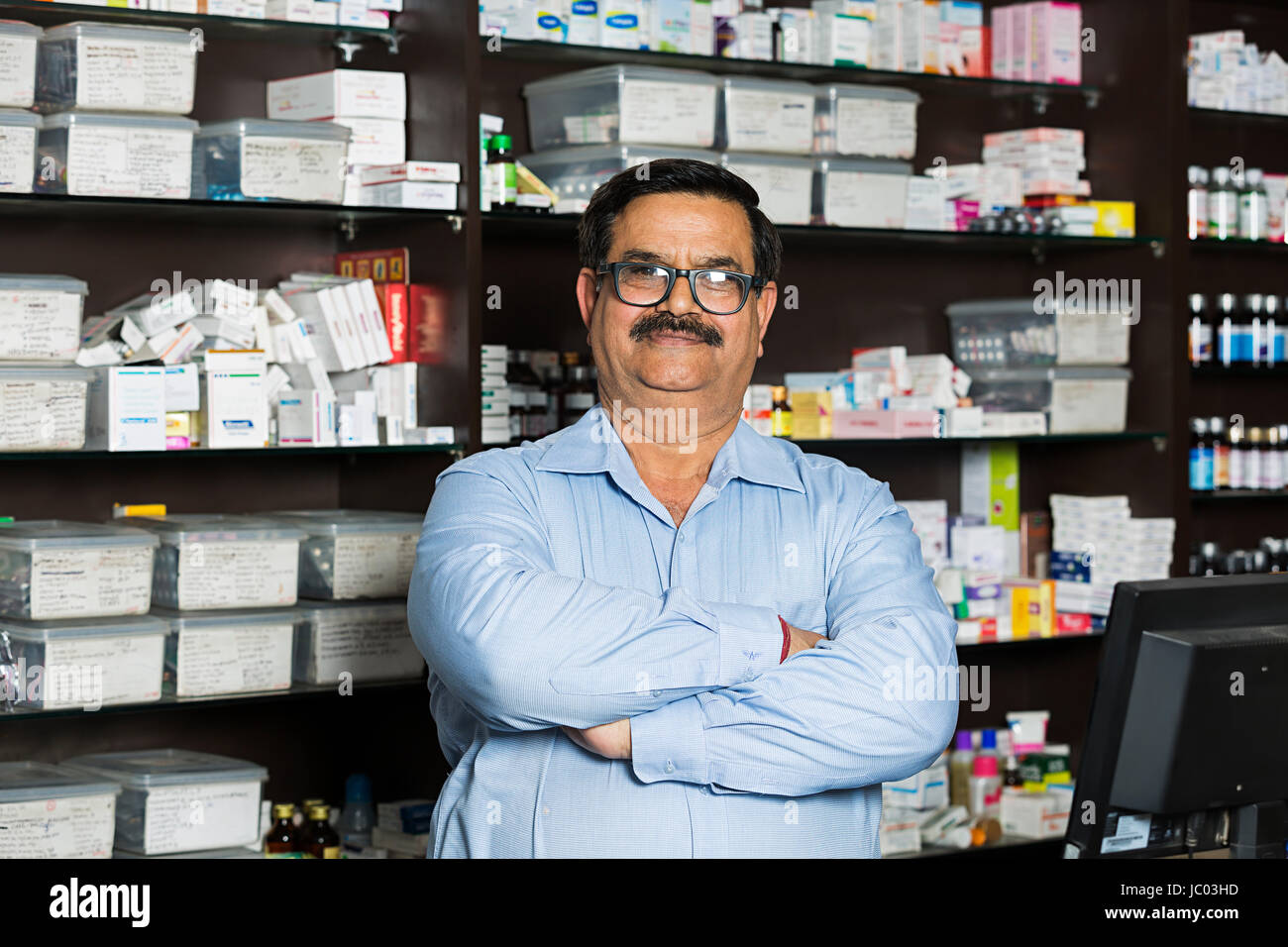 1 Indian Shopkeeper Man Arms Crossed Standing In Chemist Store keeper ...
