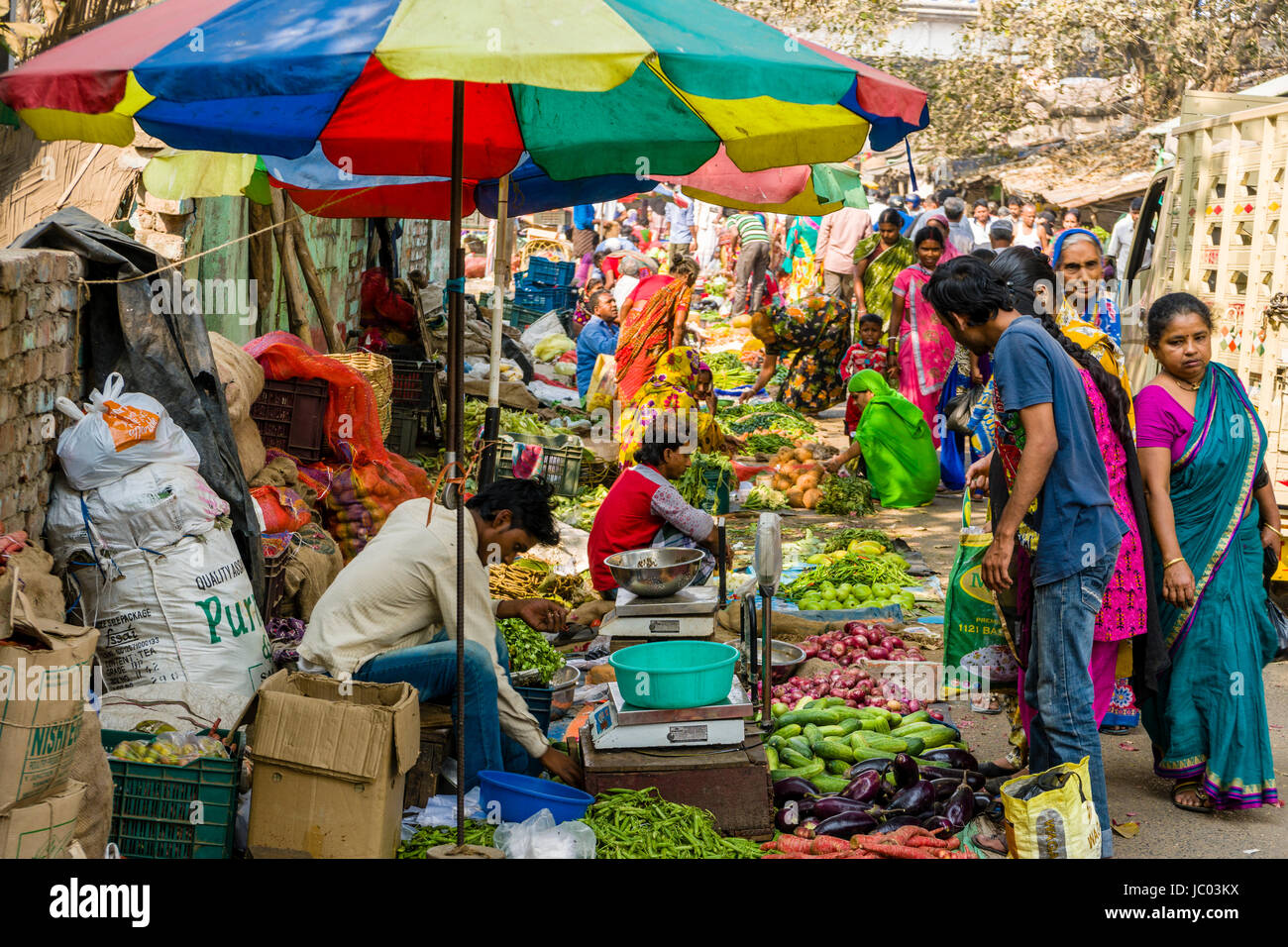 Many people on a busy vegetable market street in the suburb Park Circus ...