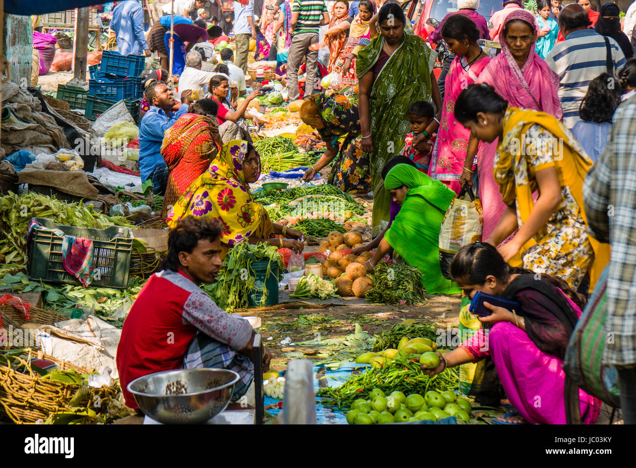 Many people on a busy vegetable market street in the suburb Park Circus ...