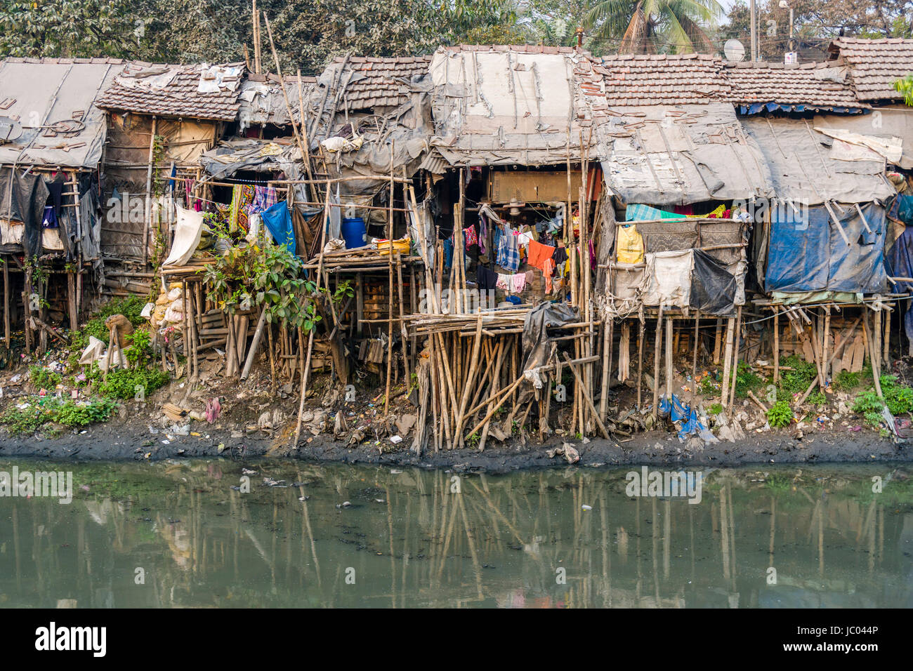 The dwellings and huts in Topsia slum are located at a dirty river ...