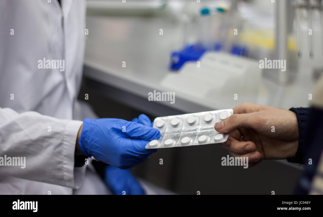 Doctor or scientist give drugs or medicaments to a patient Stock Photo ...