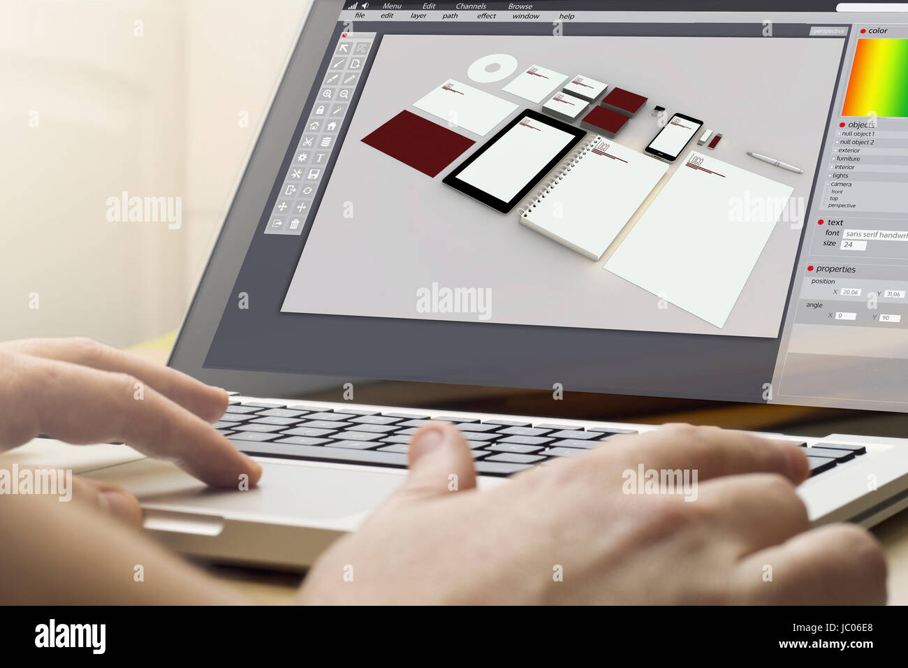 branding concept: man using a laptop with graphic design software on ...