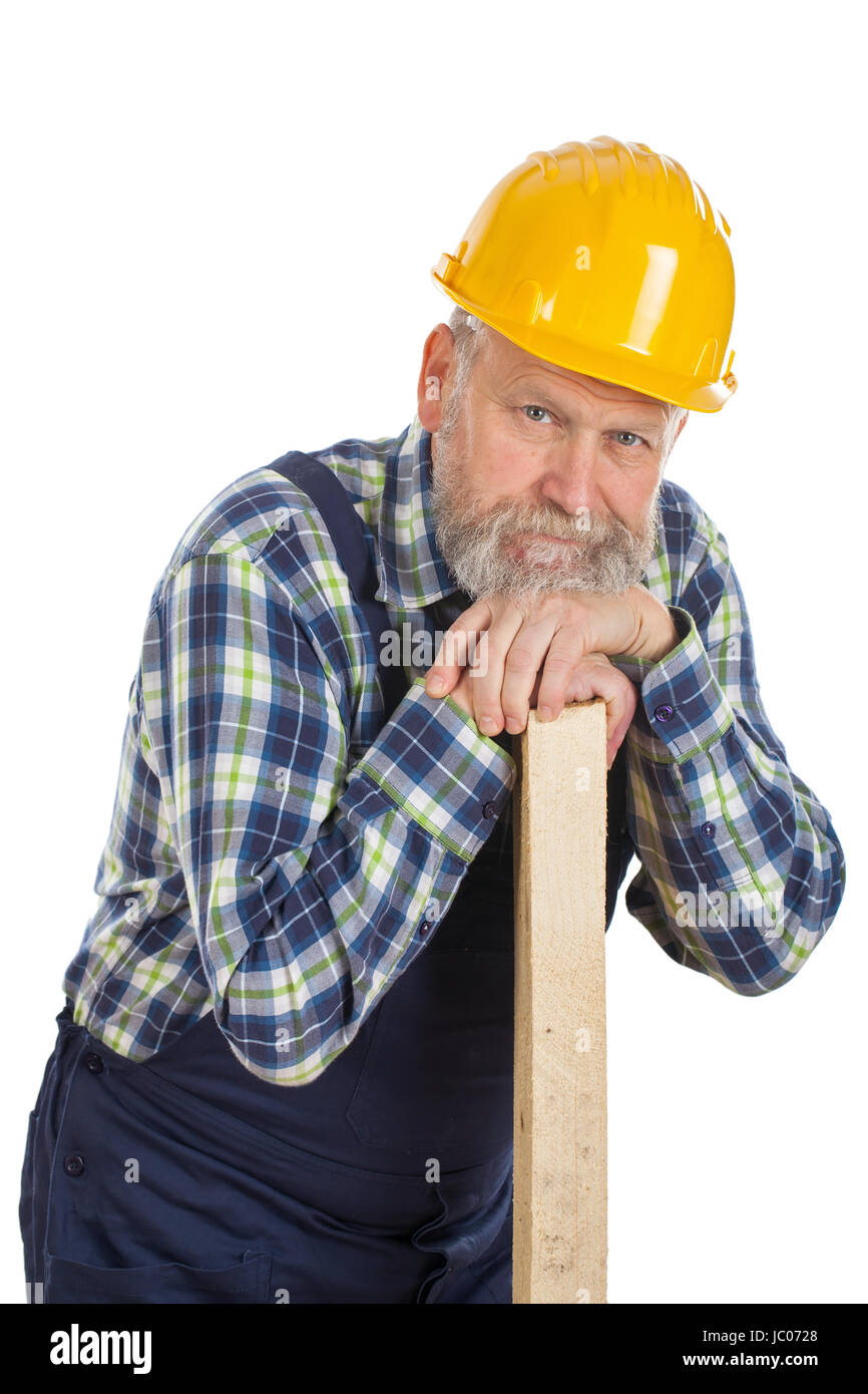 Picture of a tired male engineer posing with a yellow helmet, holding a ...