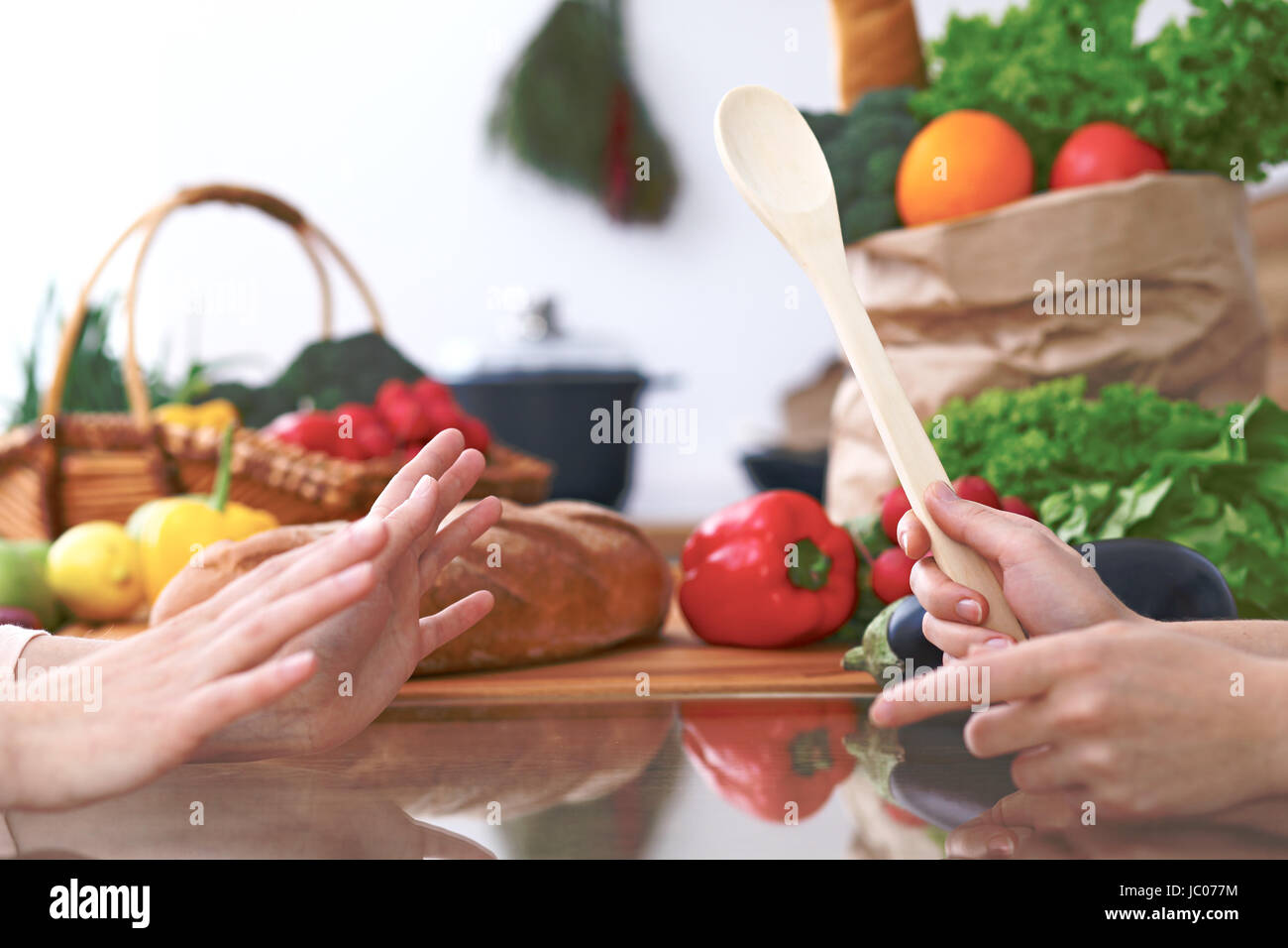 Close-up of human hands are gesticulate over a table in the kitchen ...