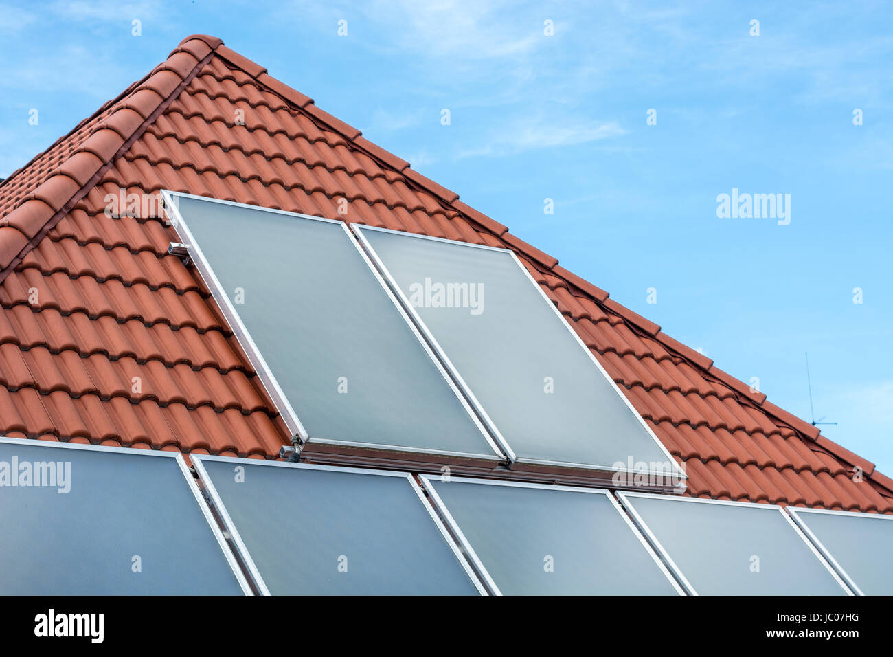 Solar panels installed on a roof with the sky Stock Photo - Alamy