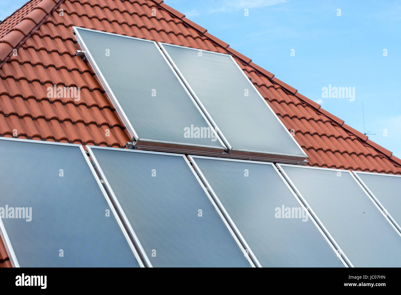 Solar panels installed on a roof with the sky Stock Photo - Alamy