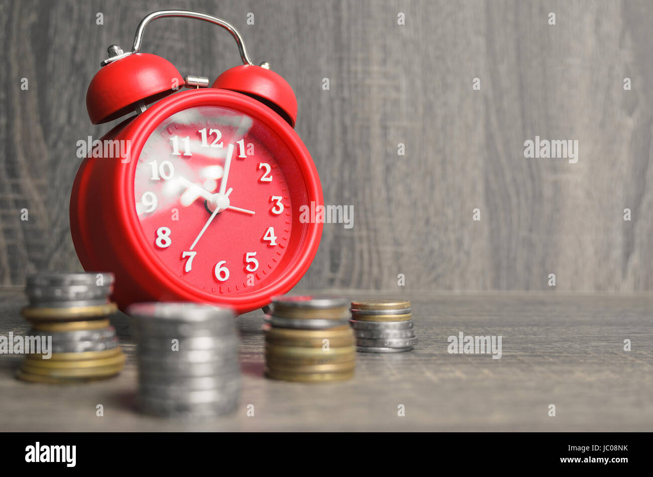 Time is money concept: Old style red clock with some money around on a ...