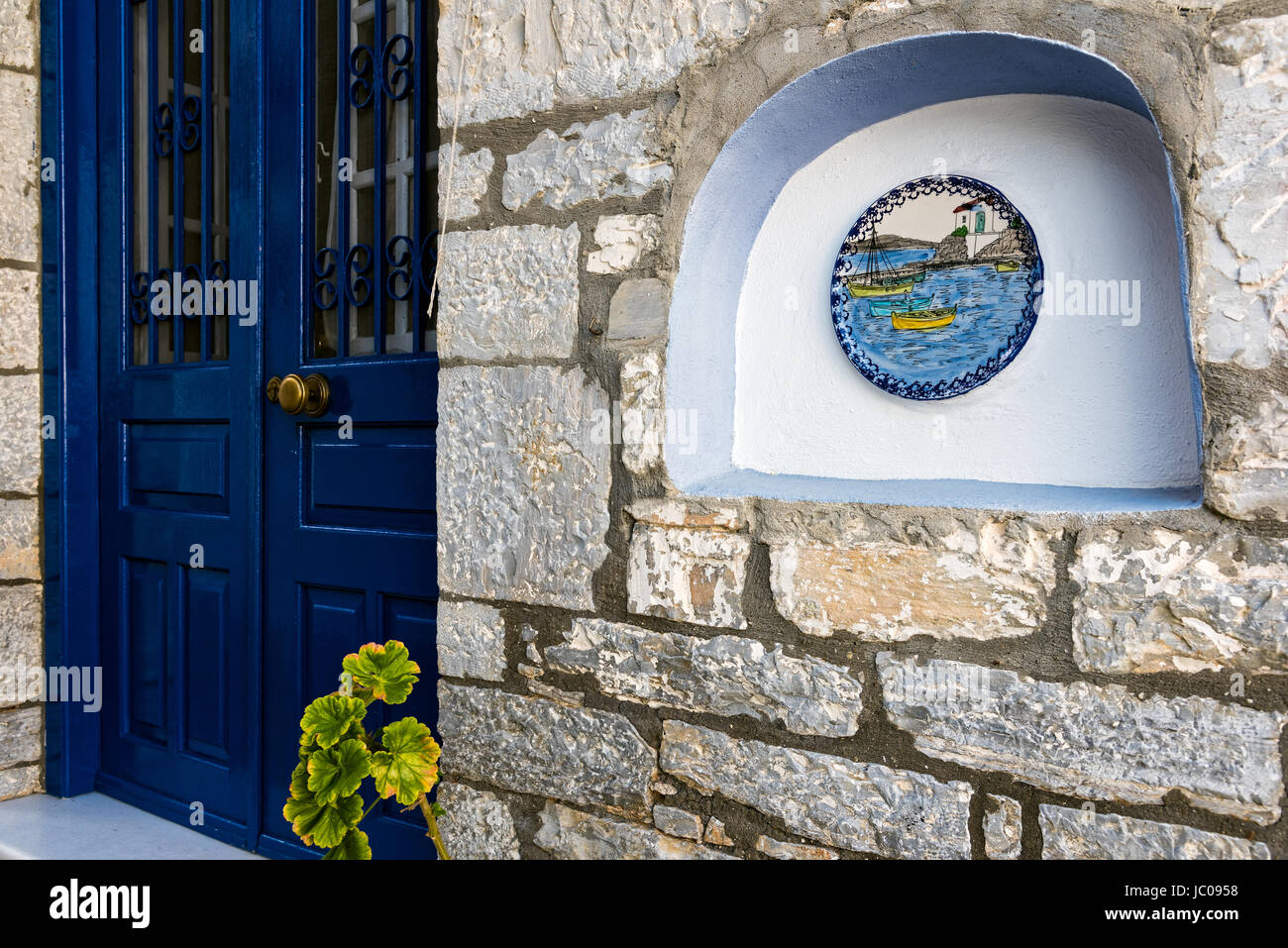 Entrance of traditional stone house, decorated with painted plate, in ...