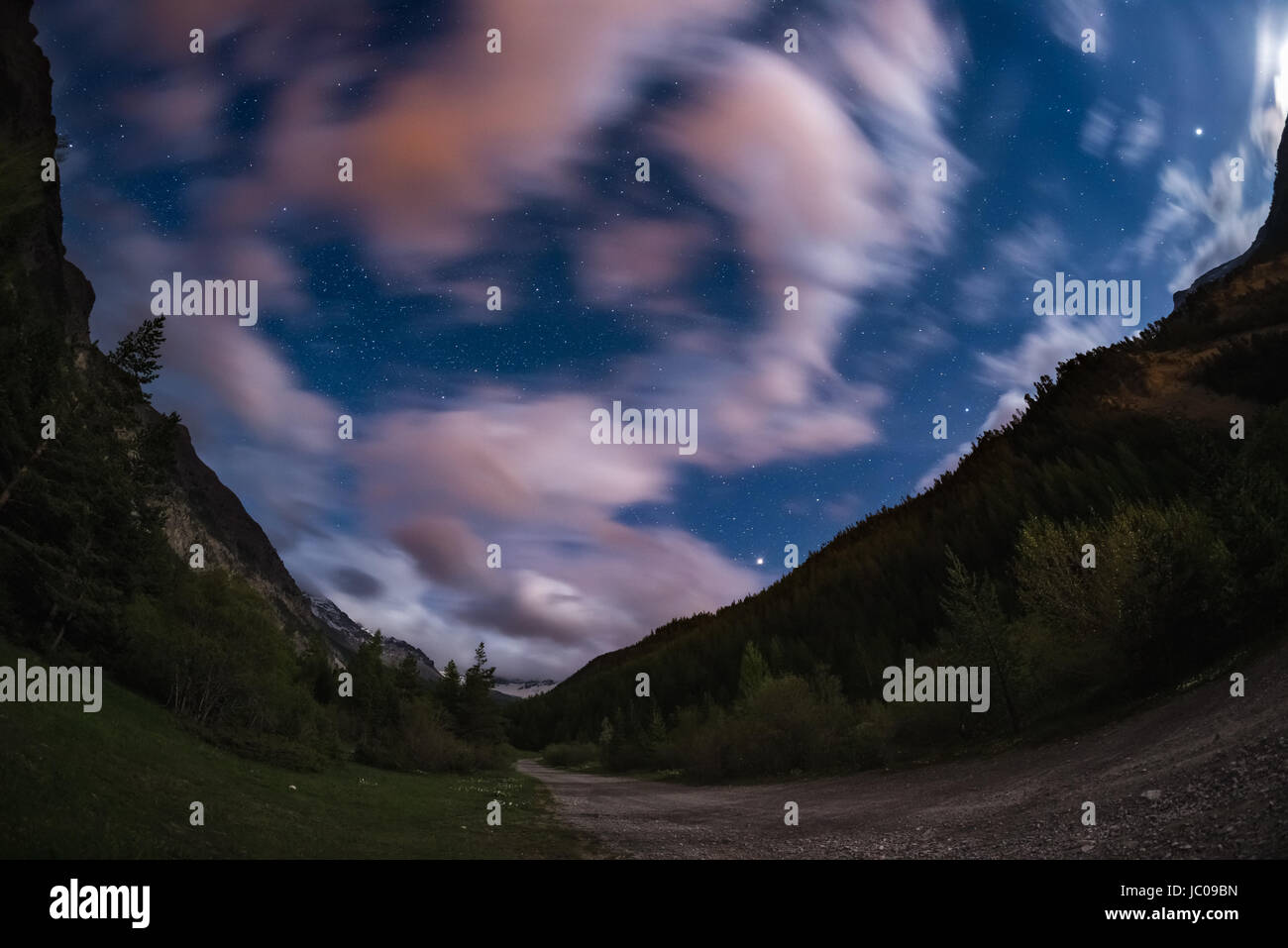 The starry sky with blurred motion colorful clouds and bright moonlight ...
