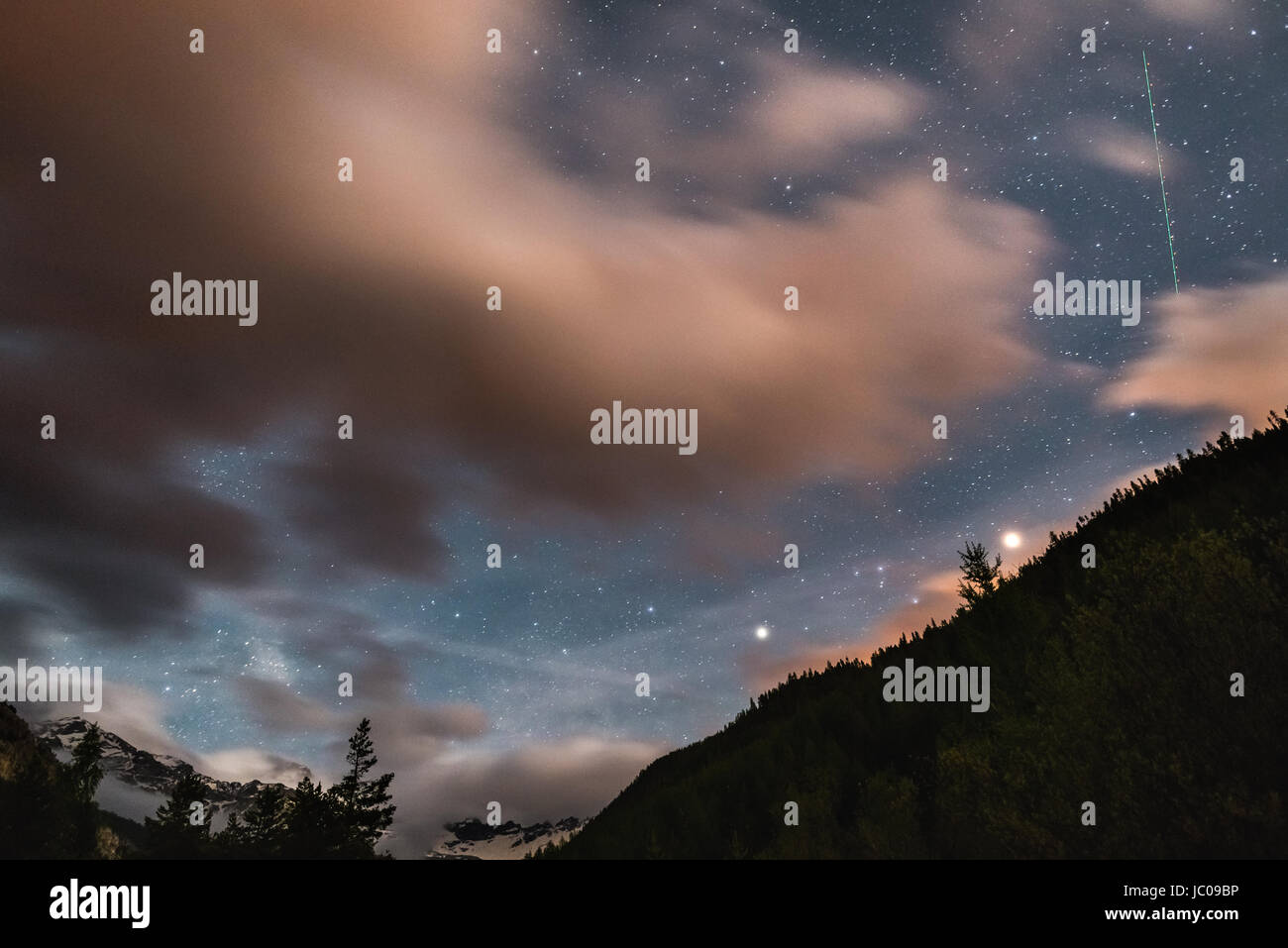 The starry sky with blurred motion colorful clouds and bright moonlight ...