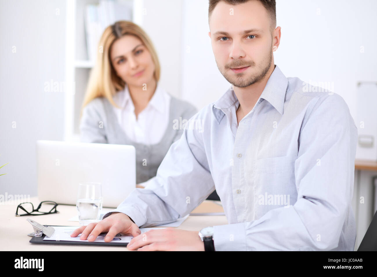 Two successful business partners working at meeting in office. Focus on ...
