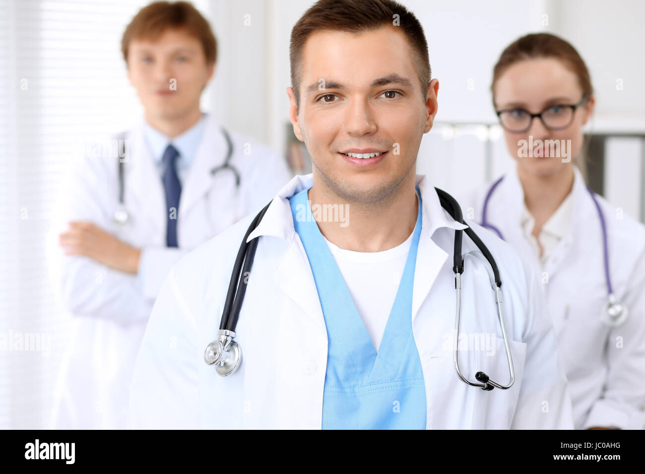 Cheerful smiling male doctor with medical staff at the hospital Stock ...