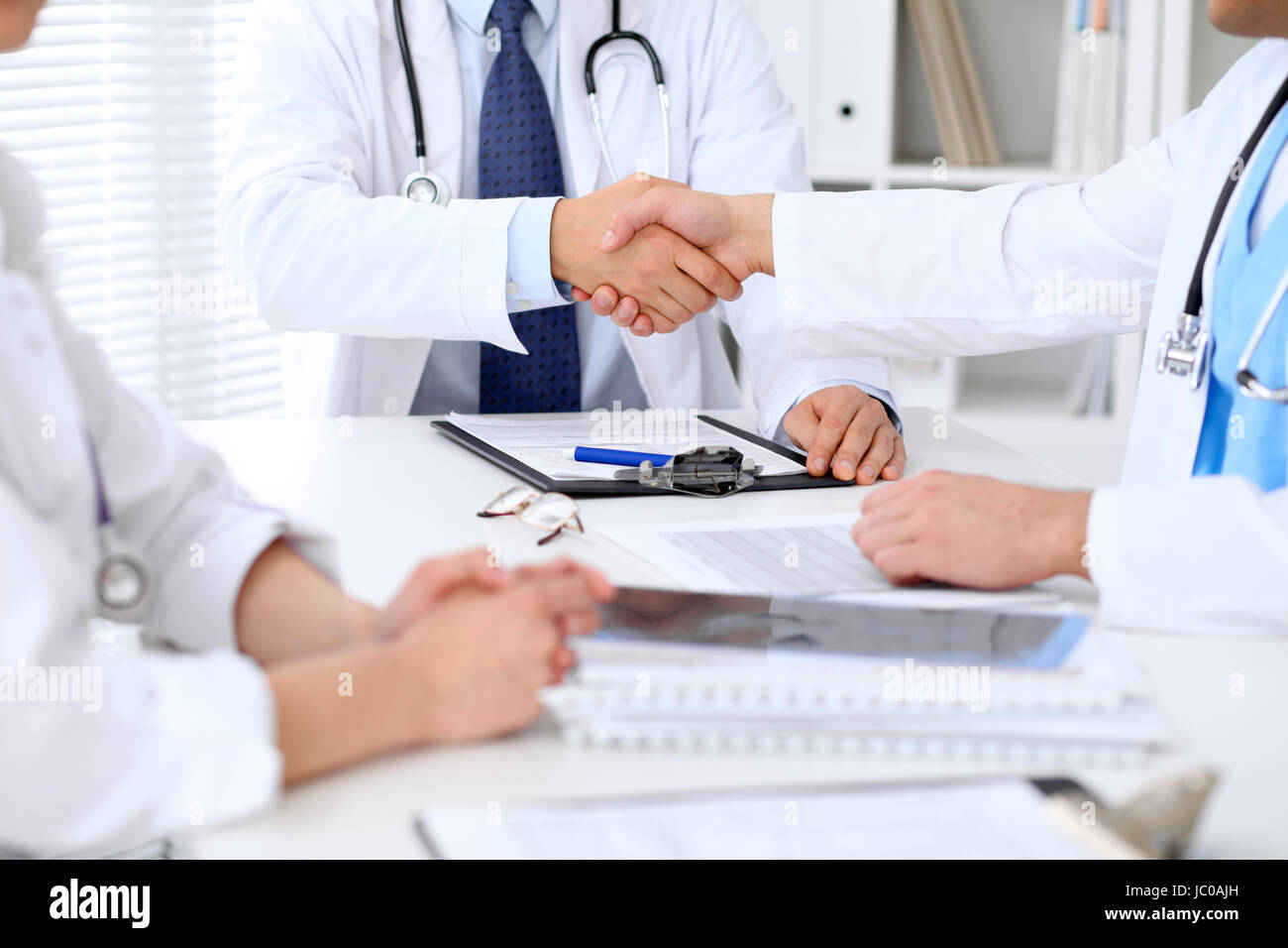 Two doctors hands in uniform hi-res stock photography and images - Alamy