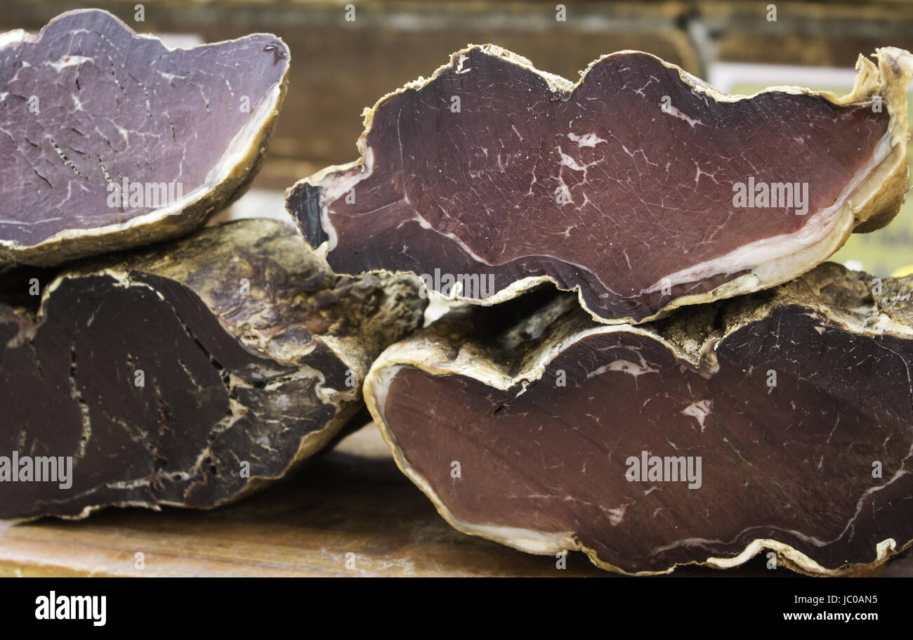 Meat of cured and dried deer, food market Stock Photo - Alamy