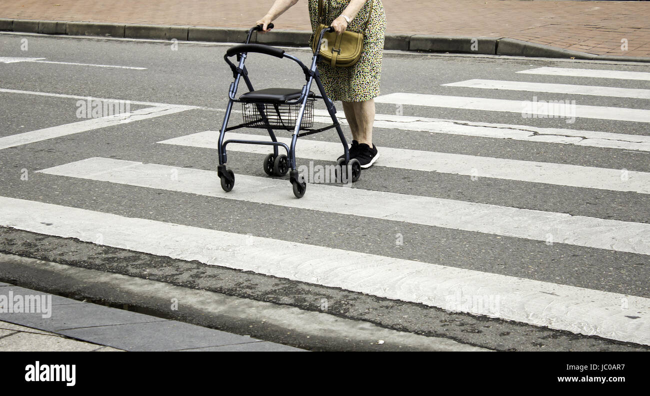 Elderly woman with walker for the disabled, illness and accessibility ...