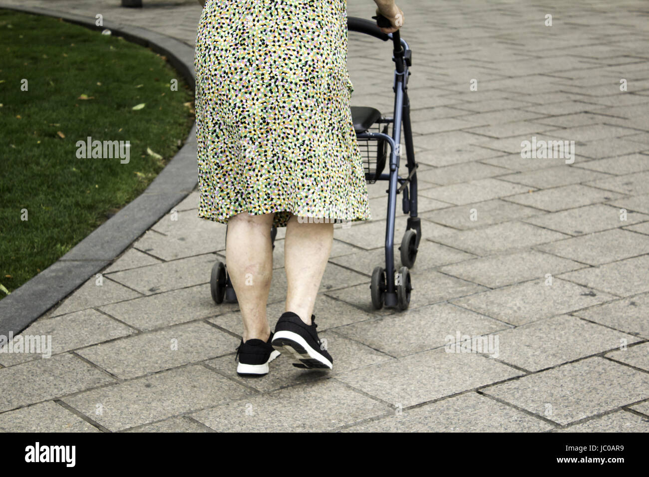 Elderly woman with walker for the disabled, illness and accessibility ...