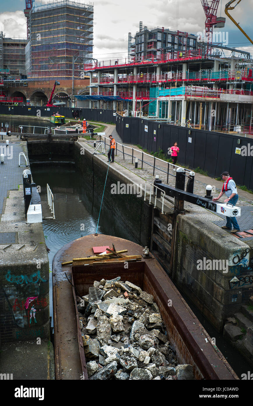 narrowboat barge full of rock rubble passing through Camden regents ...