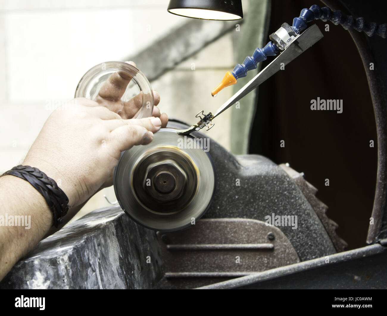 Man sharpening glass with steel lathe, work and industry Stock Photo ...