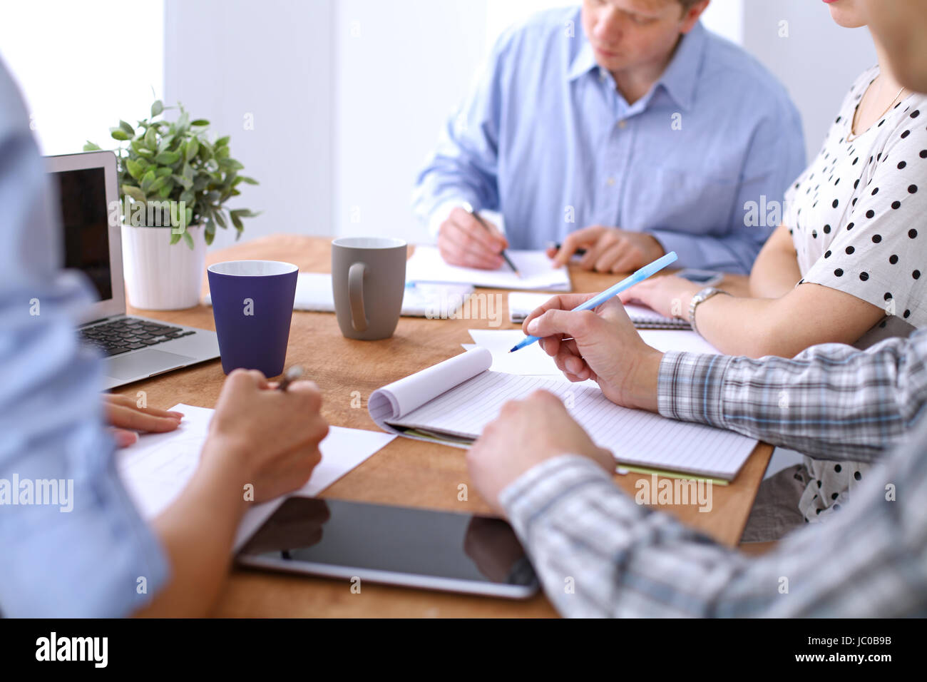 Hands of business people meeting around table Stock Photo - Alamy