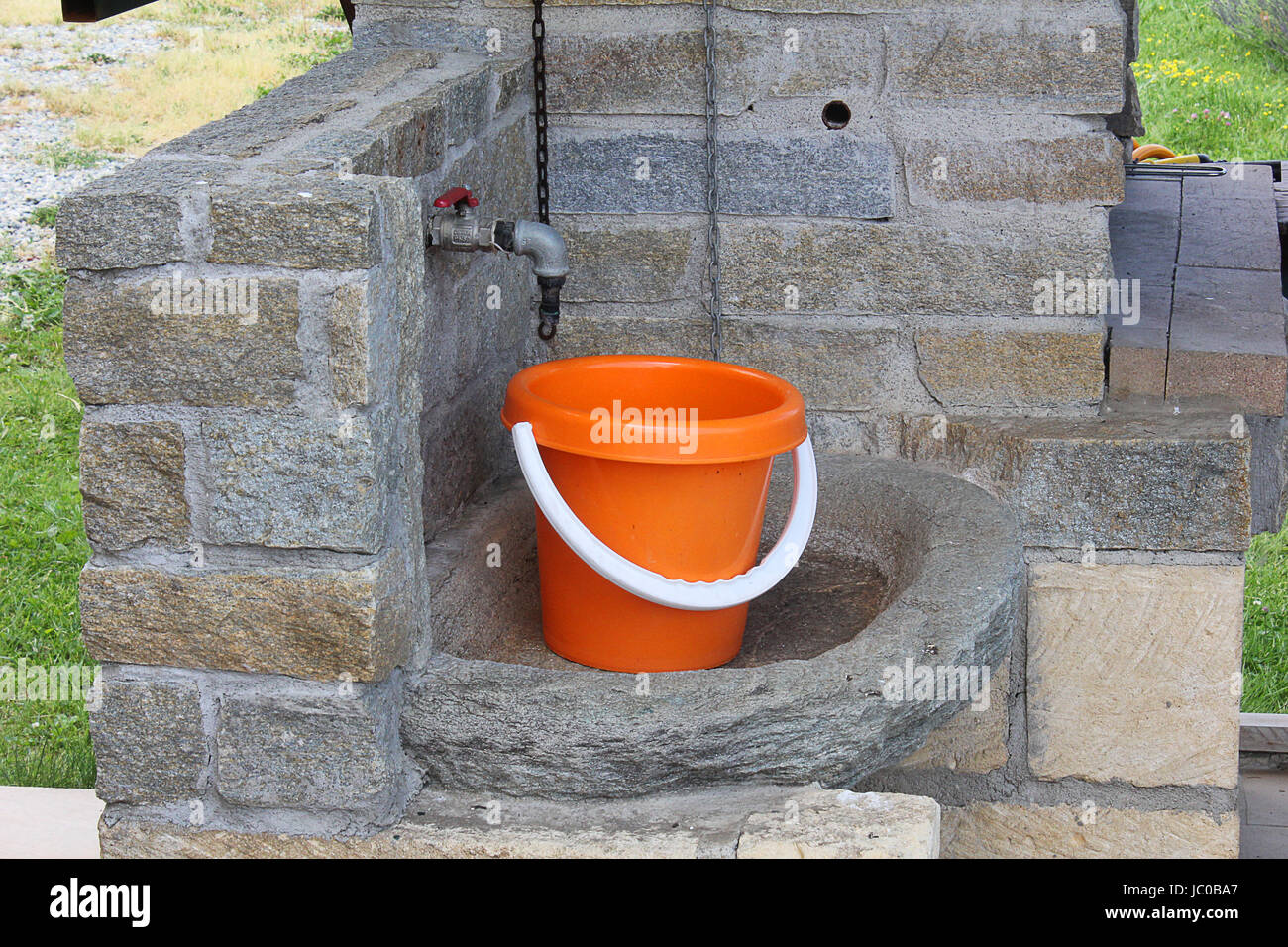 a plastic bucket in stone sink Stock Photo - Alamy