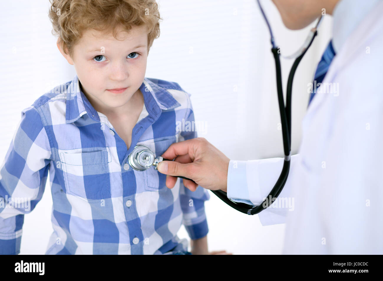 Doctor examining a child patient by stethoscope Stock Photo - Alamy