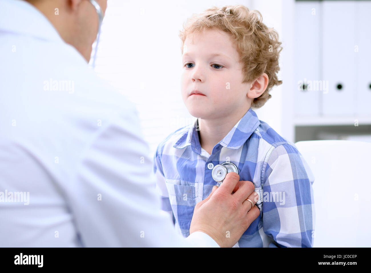 Doctor examining a child patient by stethoscope Stock Photo - Alamy