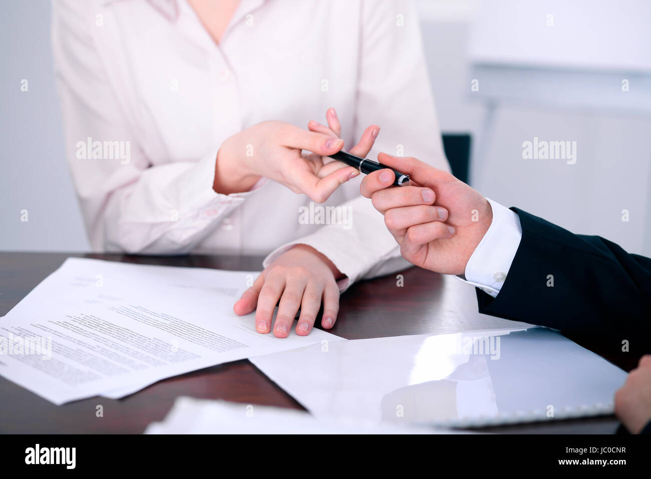 Business women giving a pen to business man for contract signing Stock ...