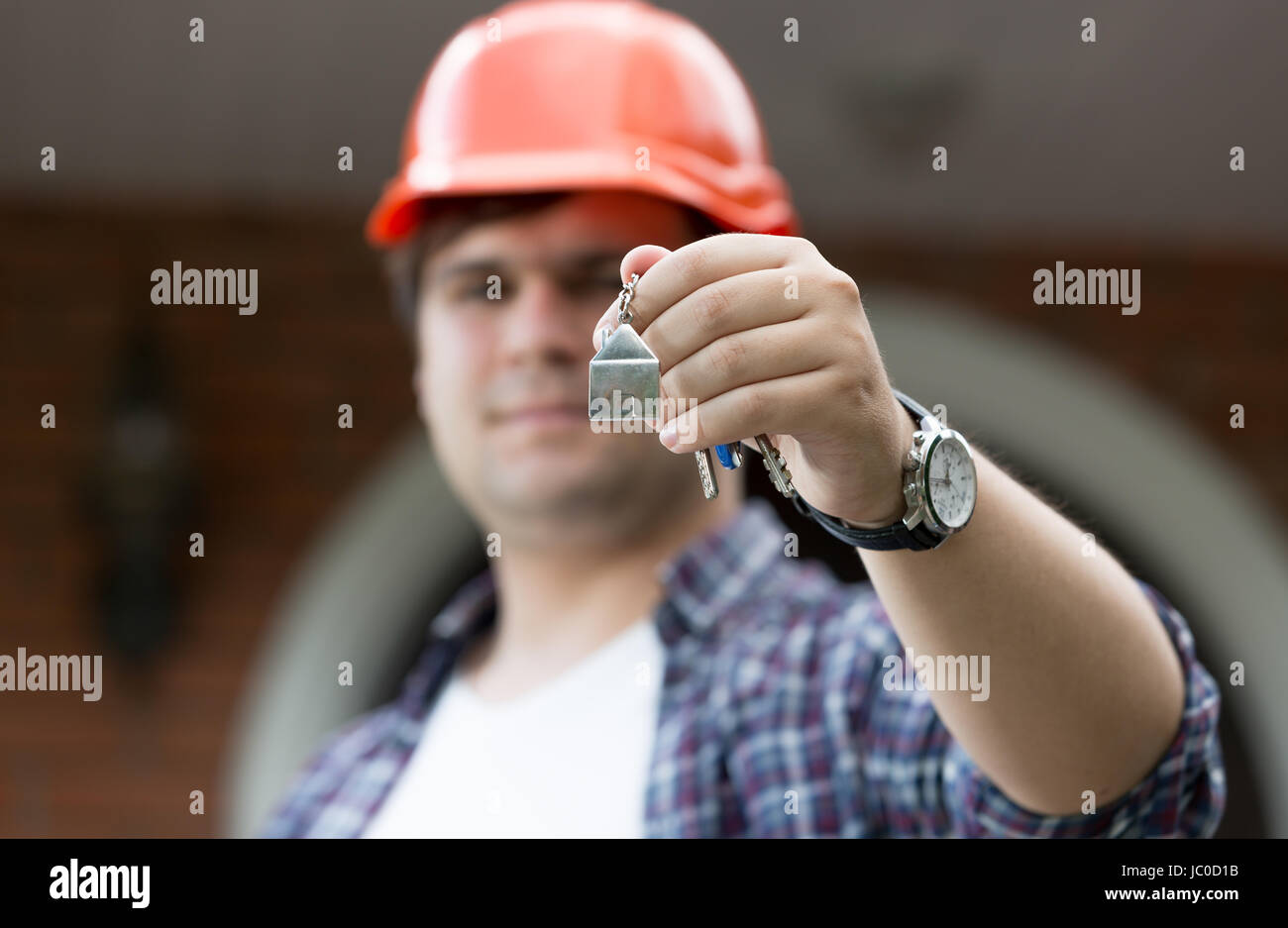Closeup photo of construction engineer giving keys from new house Stock ...