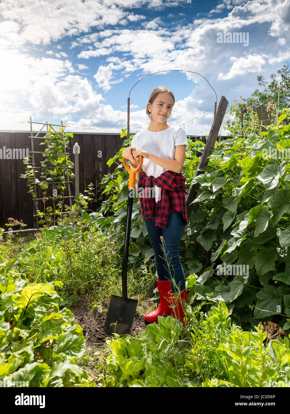 Young woman working in backyard garden at bright sunny day Stock Photo ...