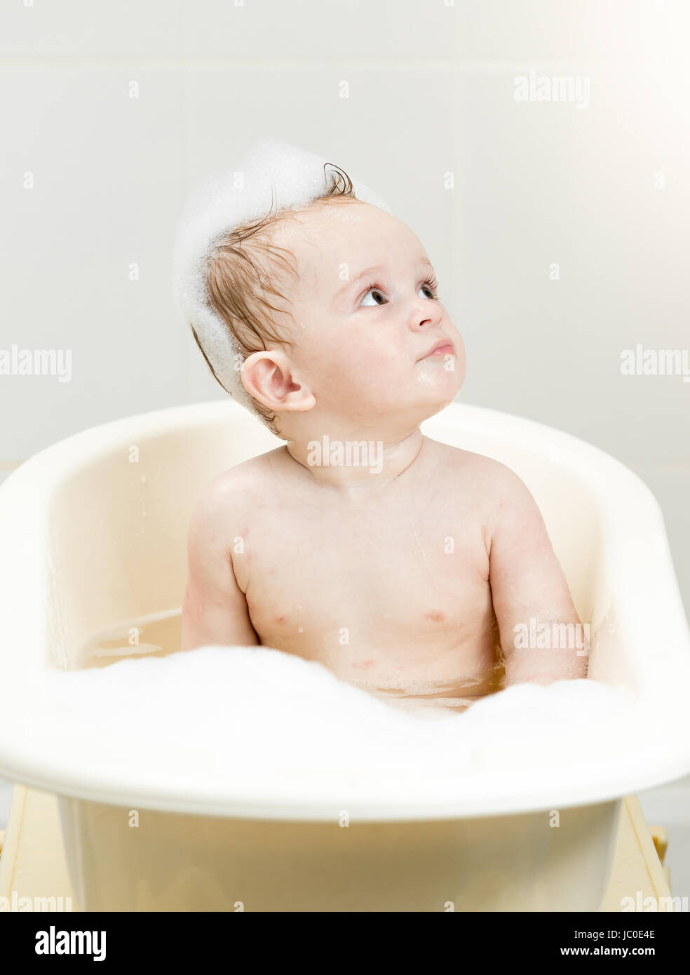 Portrait of cute baby boy having bath with foam Stock Photo - Alamy