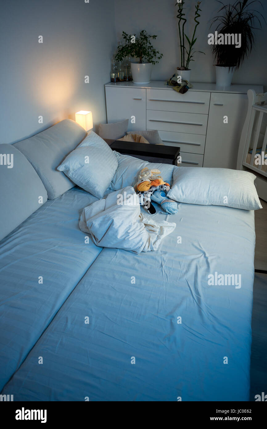 Empty bed in bedroom at late evening Stock Photo - Alamy
