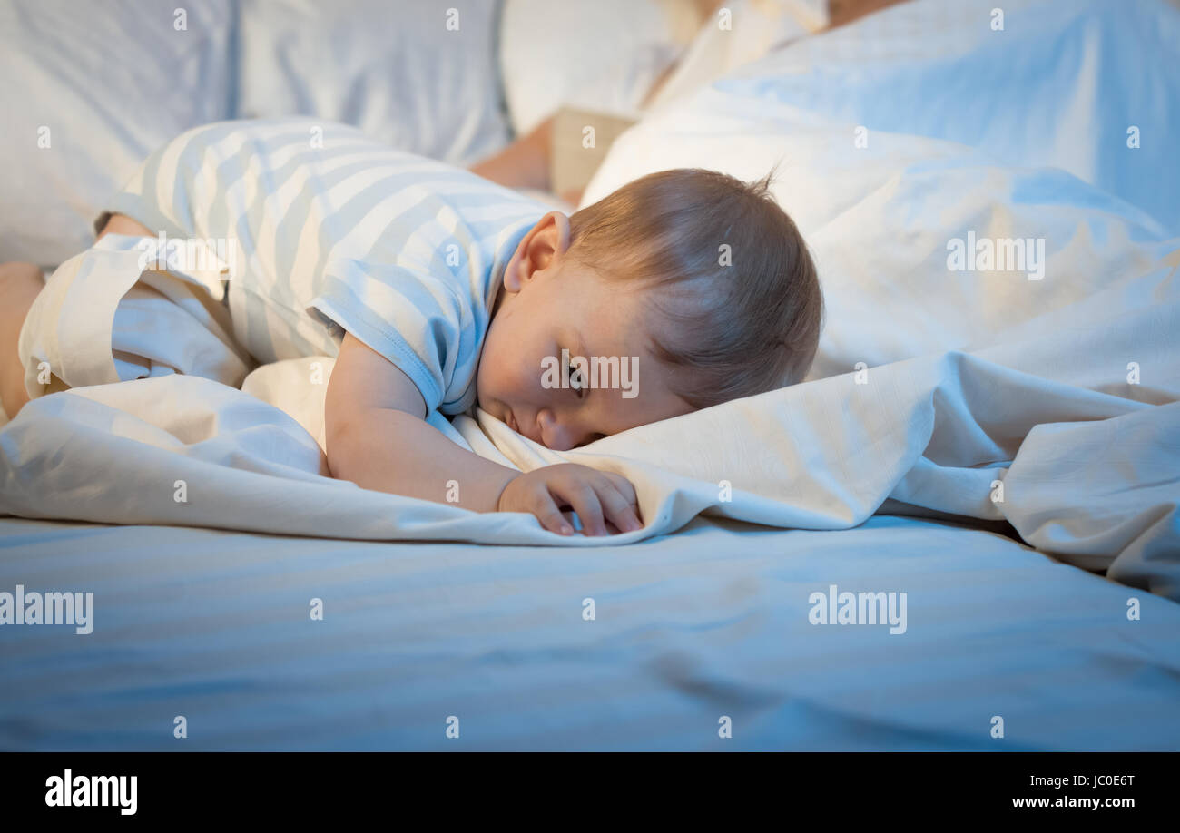 Little boy sleeping on big bed hi-res stock photography and images - Alamy