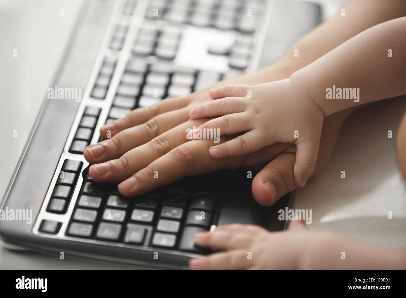 Closeup photo of fathers and baby's hands on computer keyboard Stock ...