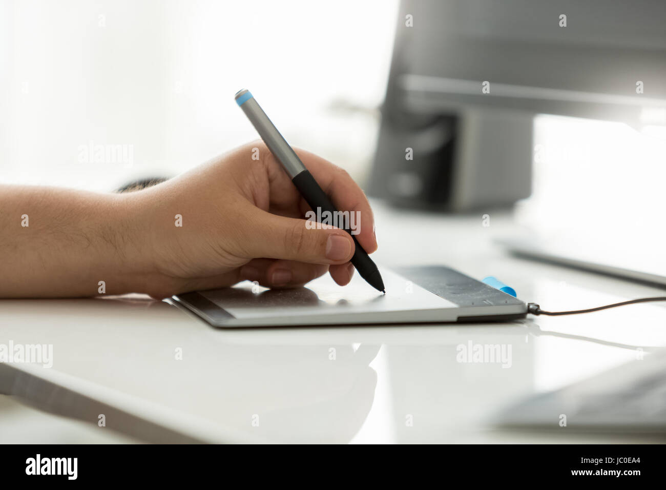 Closeup photo of professional designer using graphic tablet at work ...