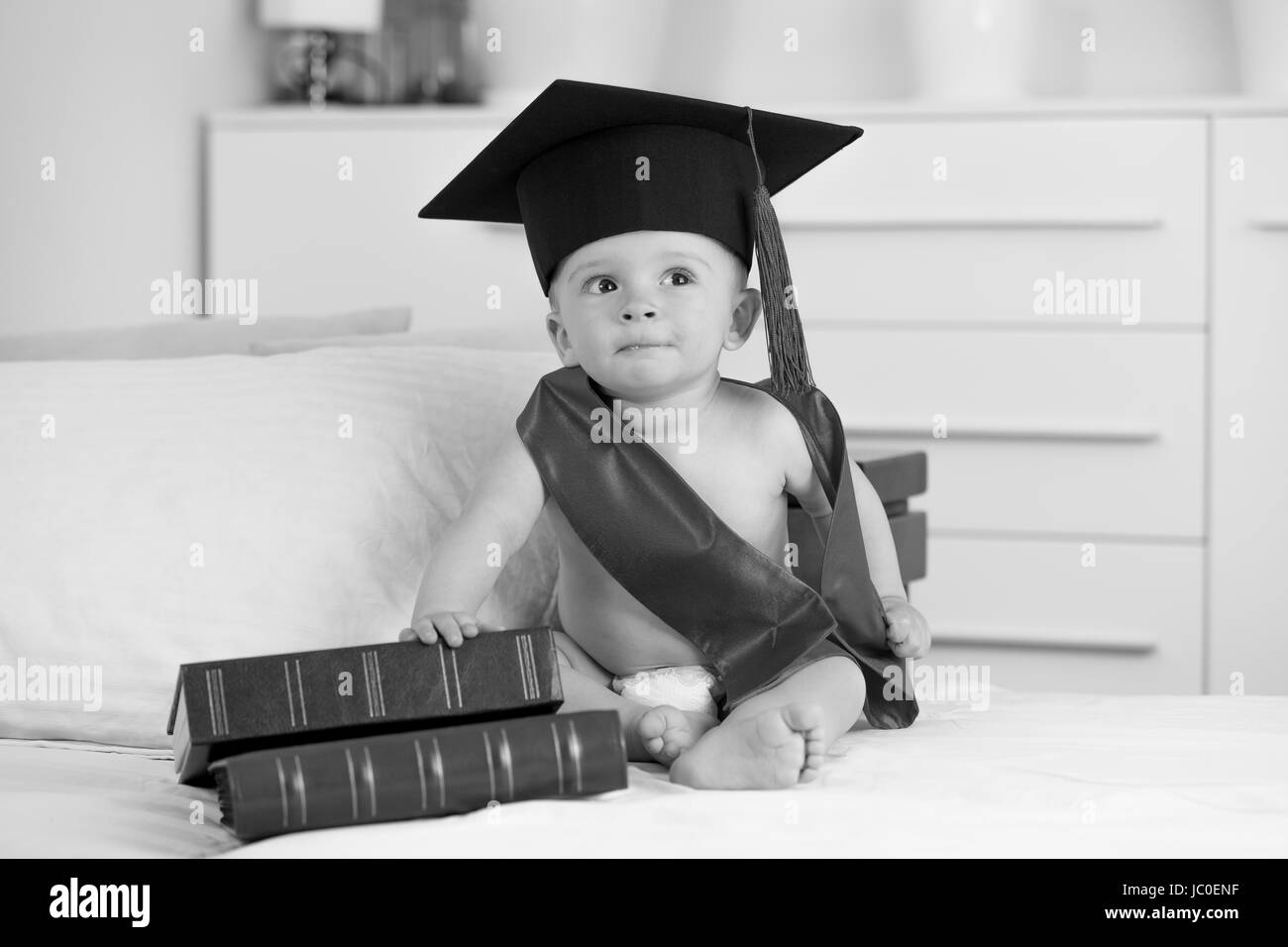 Black and white portrait of cute baby boy in graduation sitting with ...